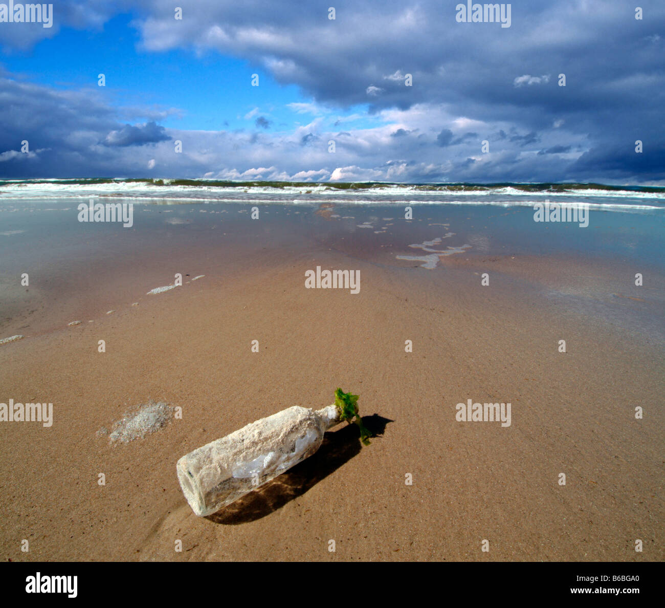 Empty bottle on beach Stock Photo - Alamy