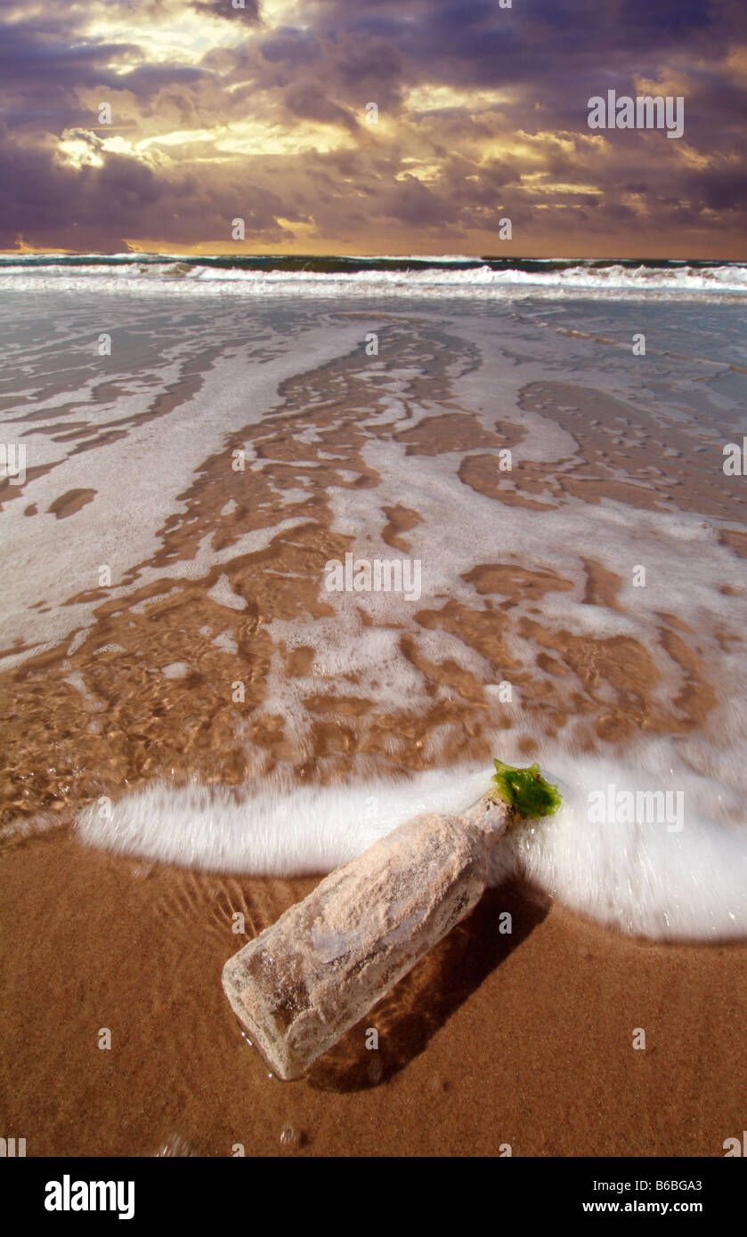 Empty bottle on beach Stock Photo - Alamy