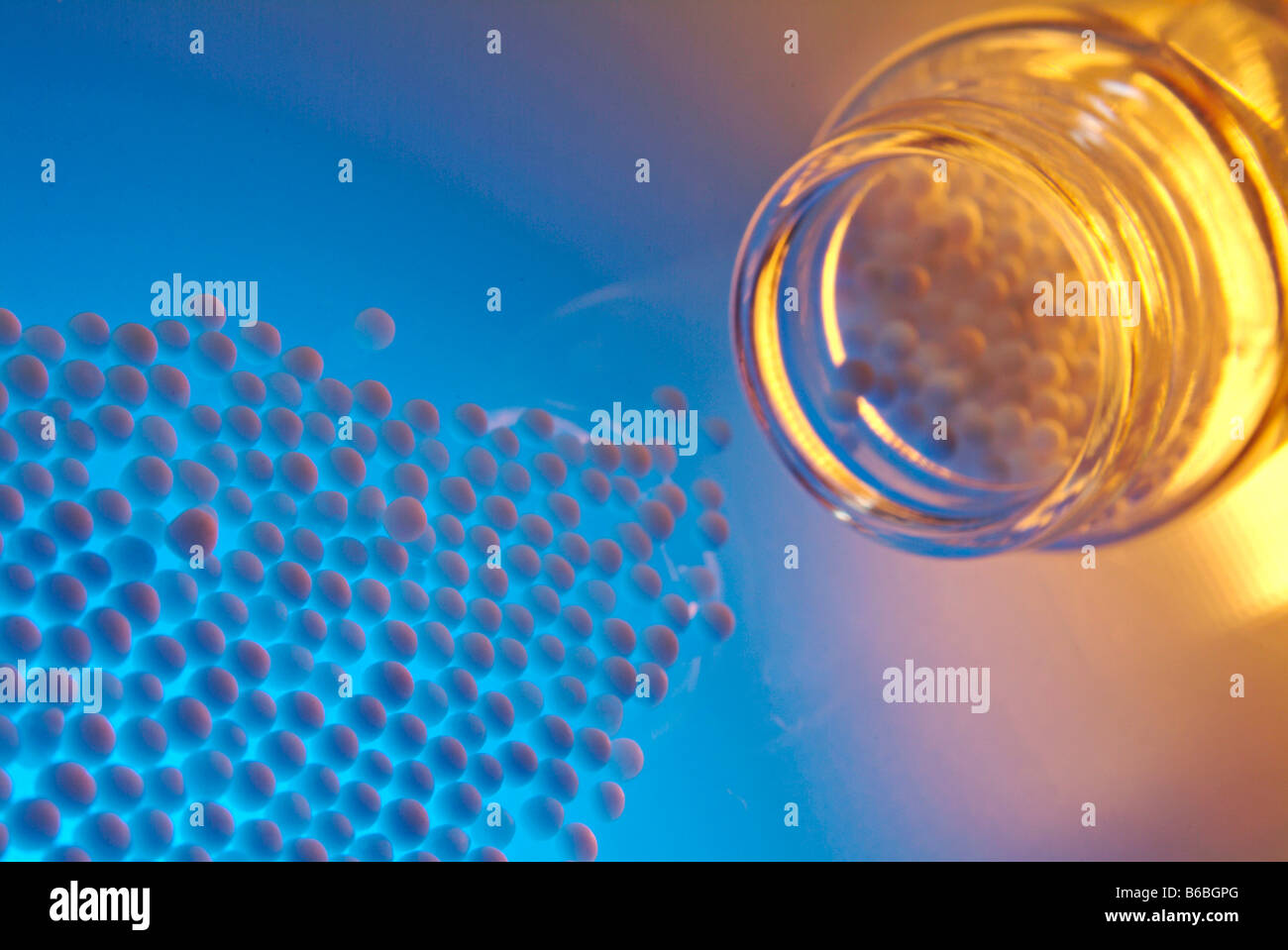 Pills spilling from bottle Stock Photo - Alamy
