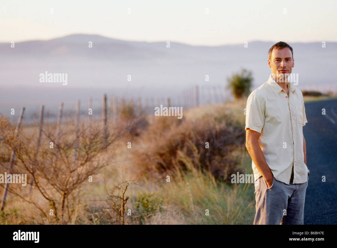 Portrait of man standing at roadside Stock Photo - Alamy