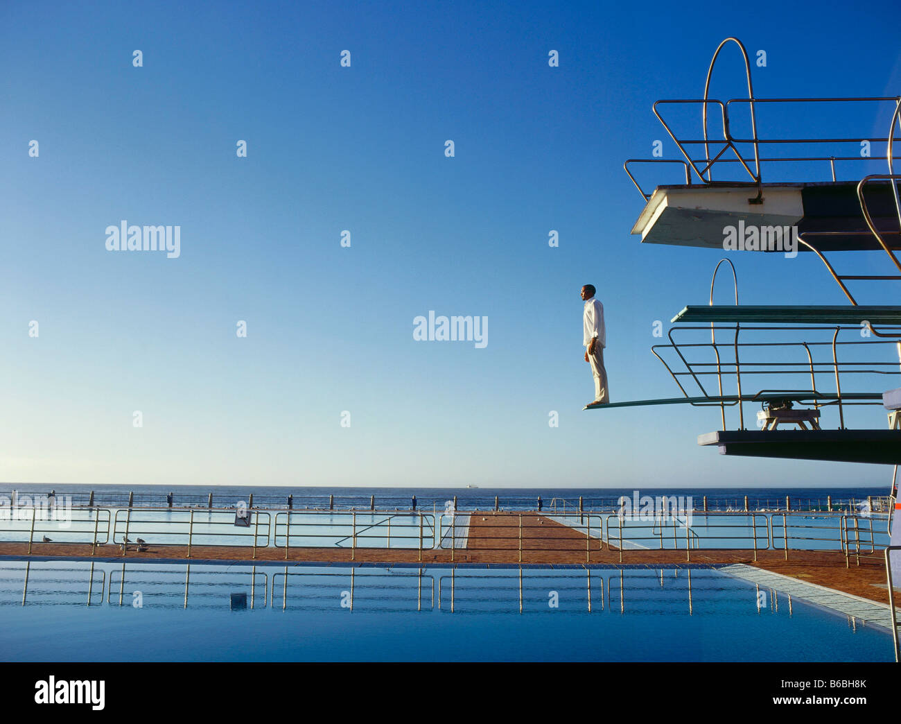 Side profile of man standing on diving board Stock Photo - Alamy