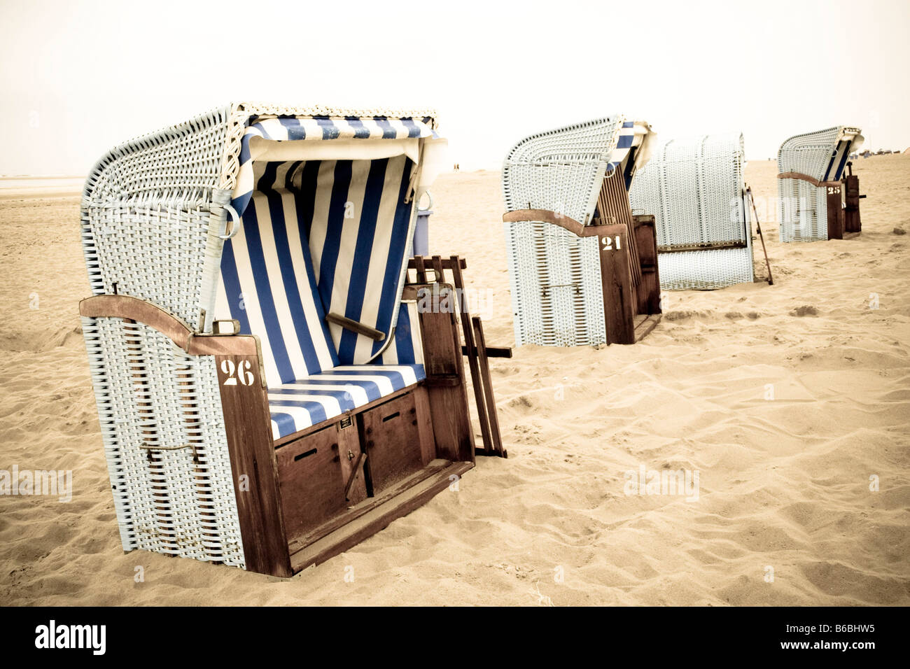 Wicker beach chairs on beach Stock Photo - Alamy
