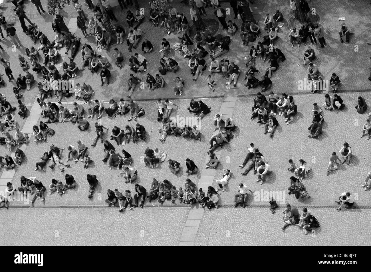 Crowd of people sitting on steps taken from the Pompidou centre, Paris ...