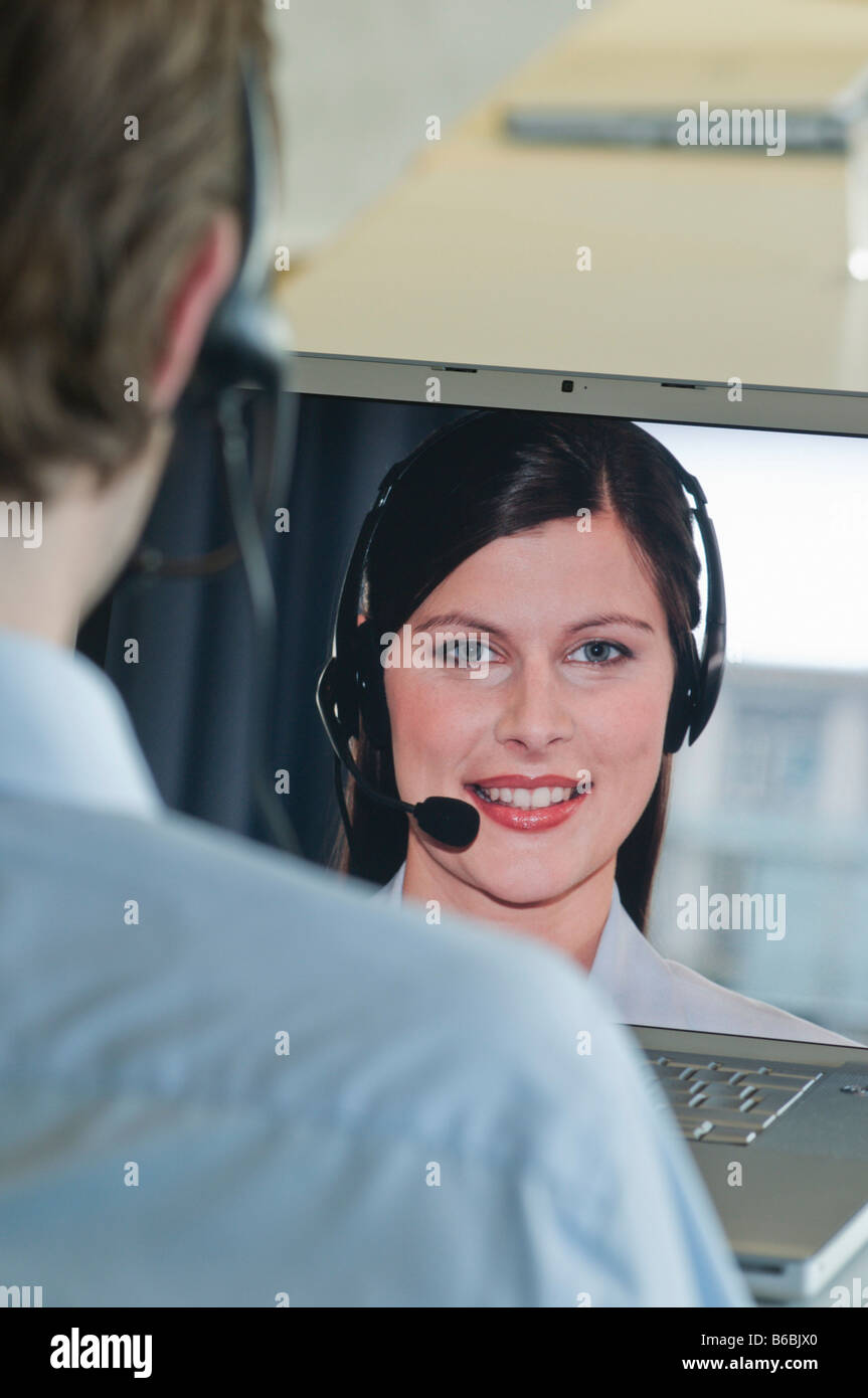 Male customer service representative working on laptop Stock Photo - Alamy
