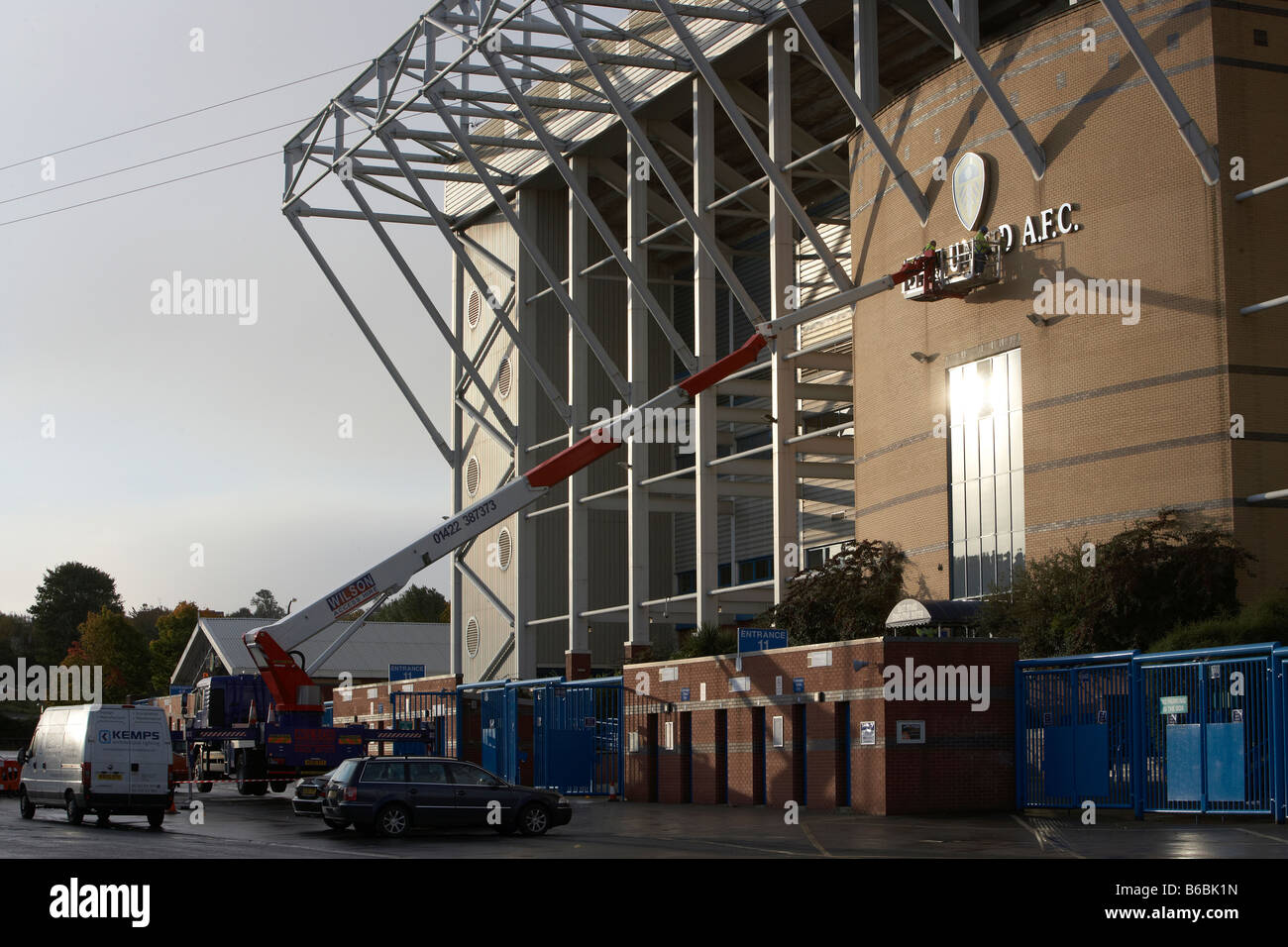 Lighting maintenance working fixing light sign at Leeds United ground ...
