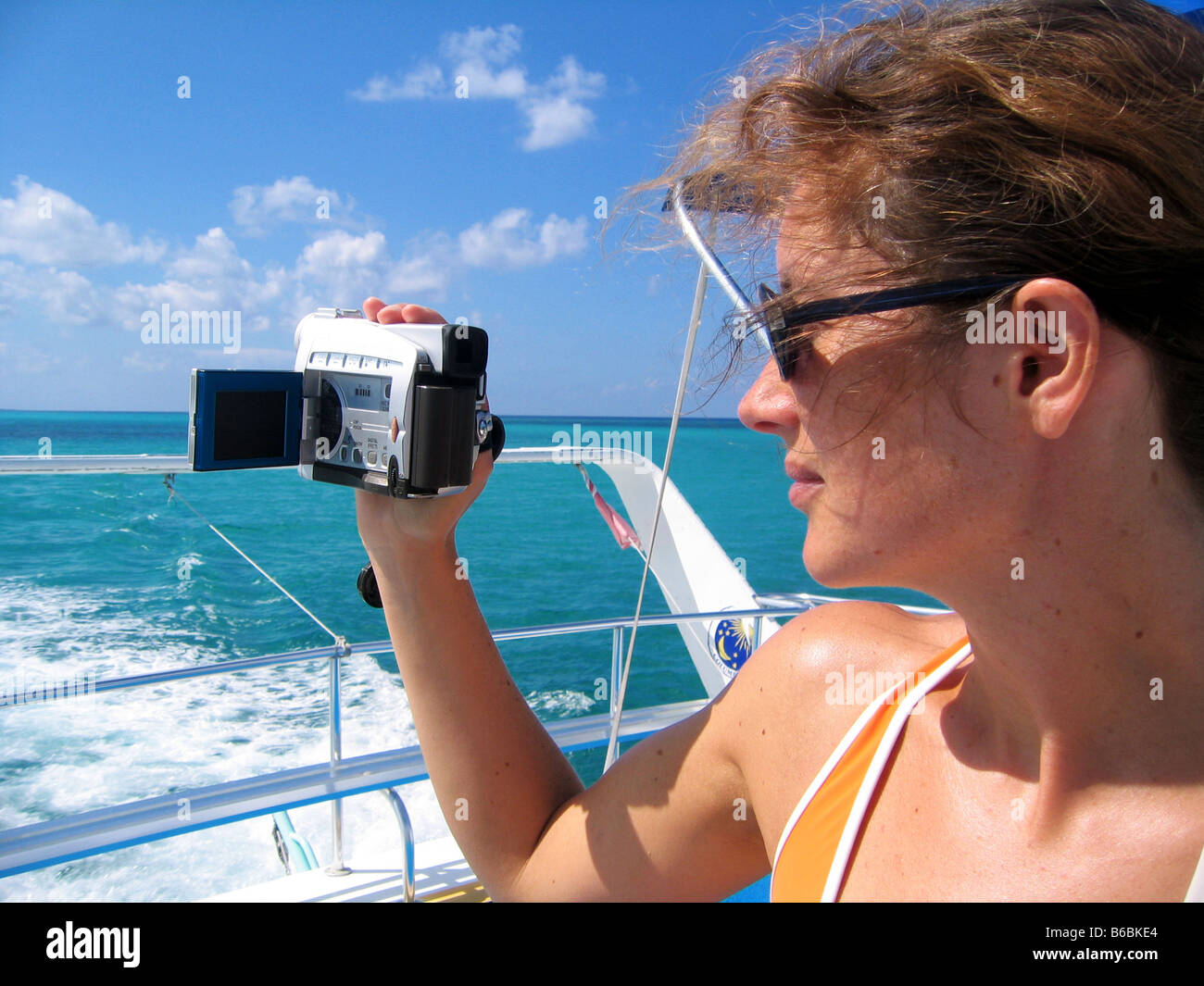 Woman filming sea with home video camera Stock Photo - Alamy