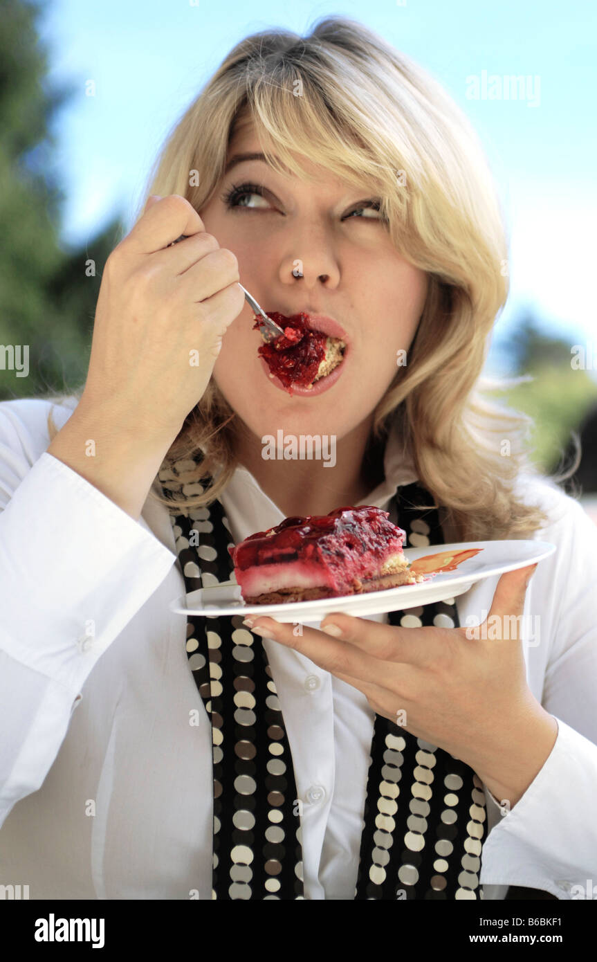 Close-up of woman eating cake Stock Photo - Alamy