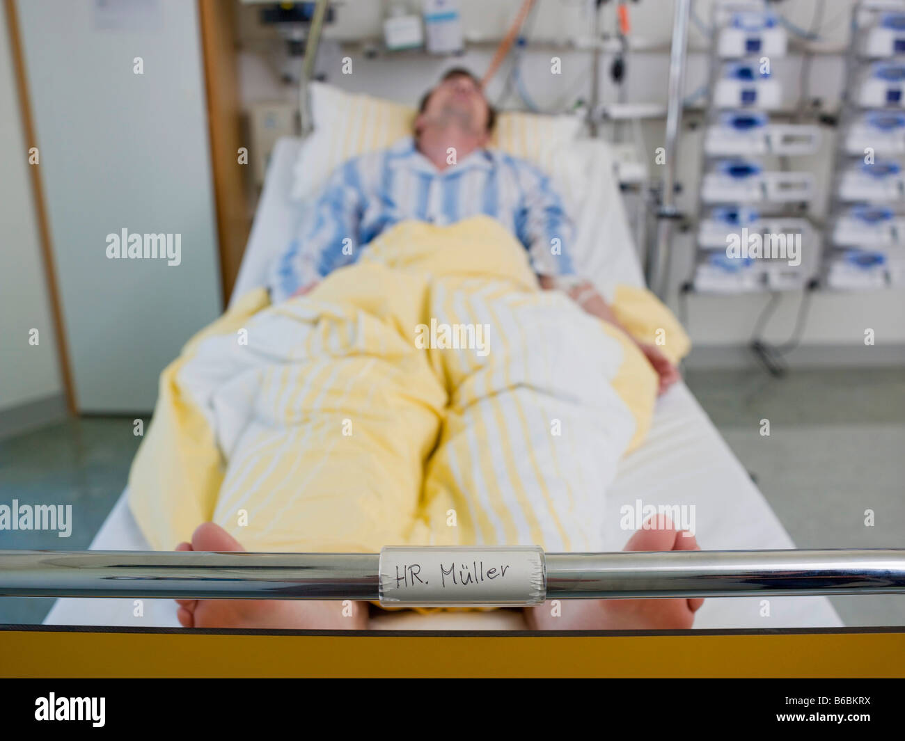 Man lying in hospital bed Stock Photo - Alamy