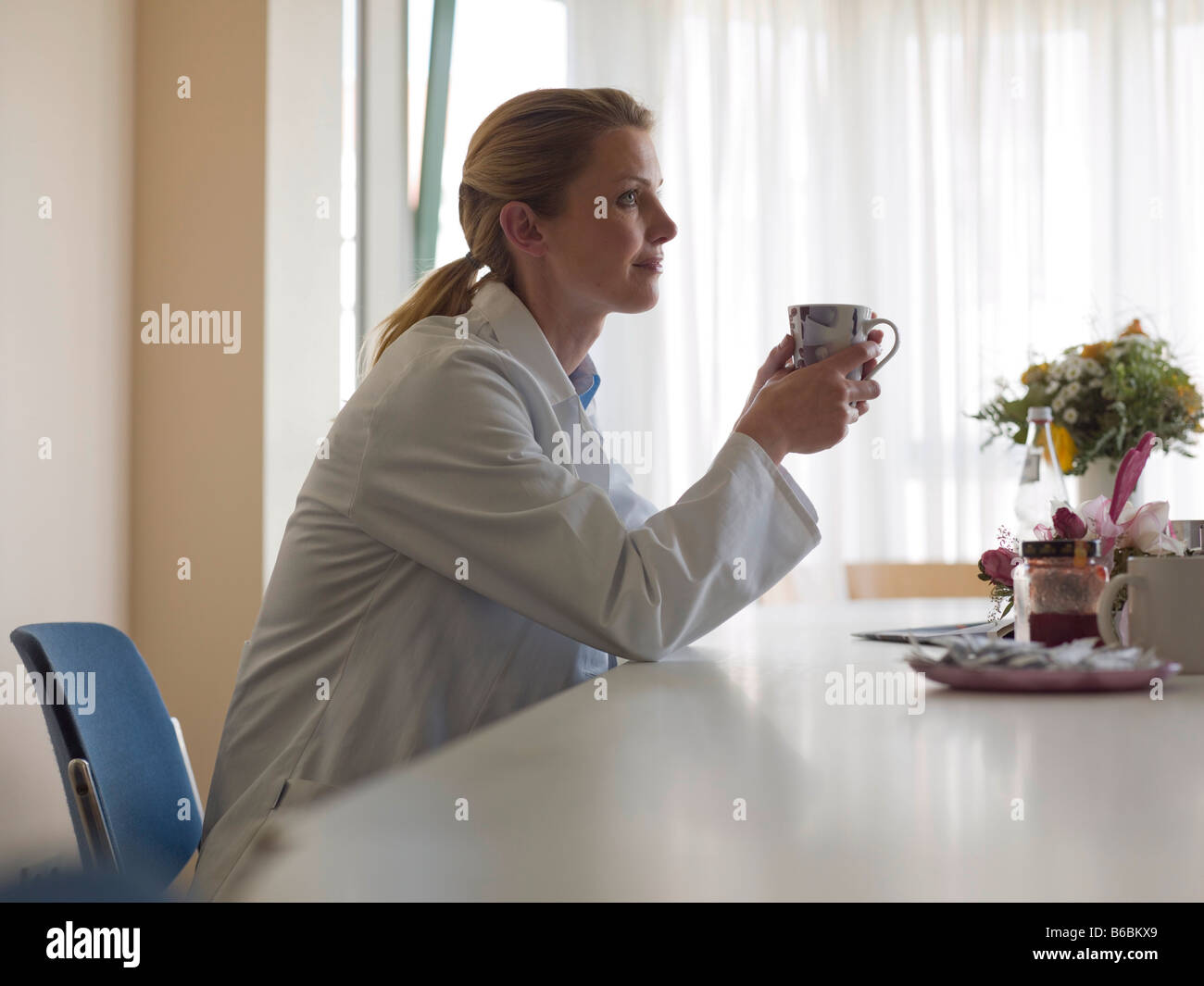 Female doctor drinking coffee Stock Photo - Alamy