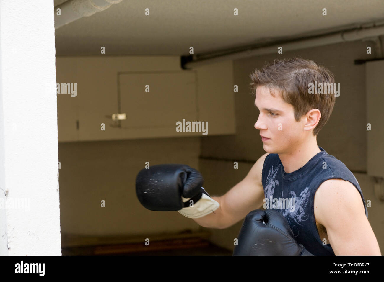 Young man practicing boxing, side view Stock Photo - Alamy