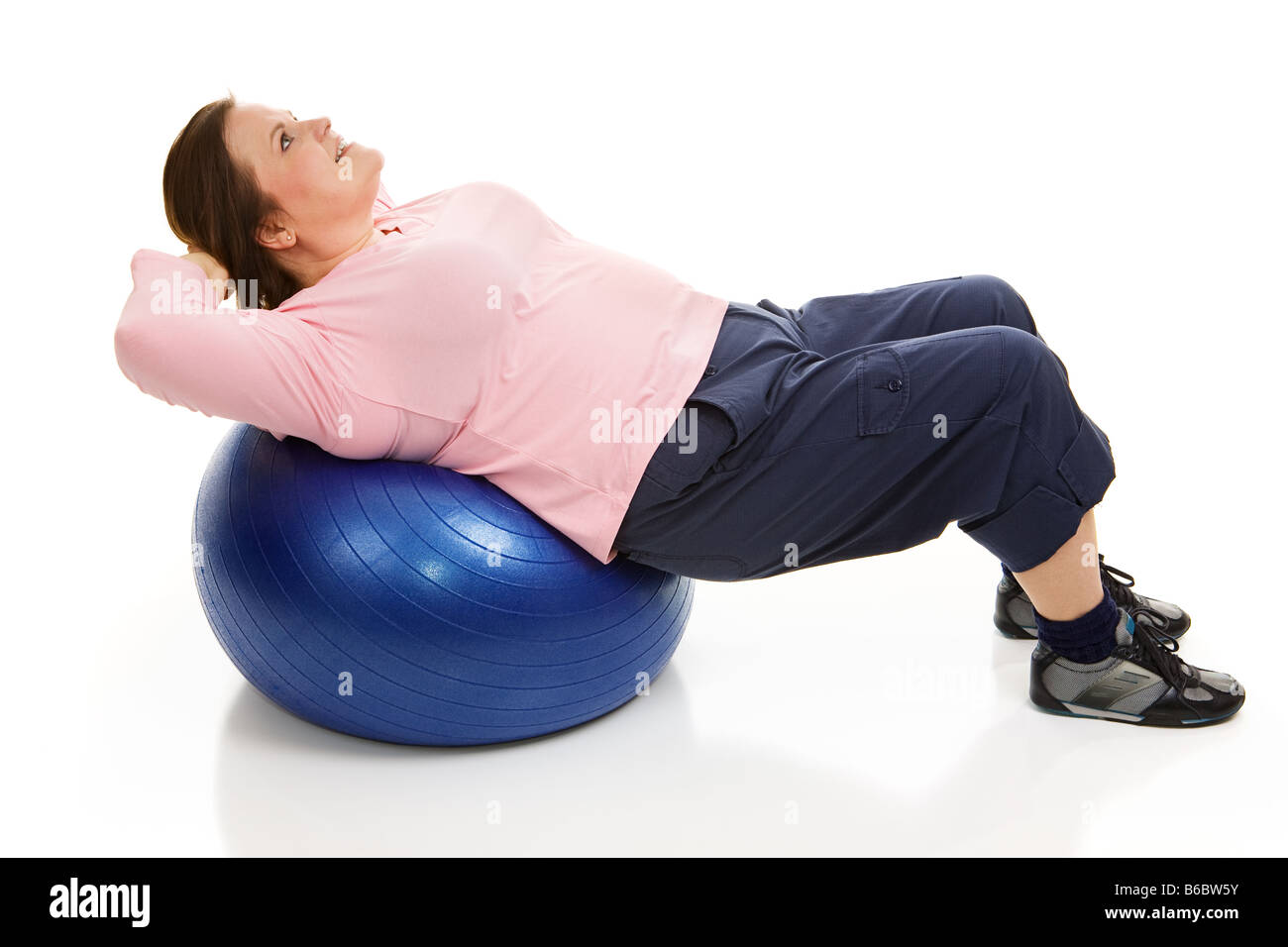 Beautiful plus sized model doing pilates to tighten her abdominal ...