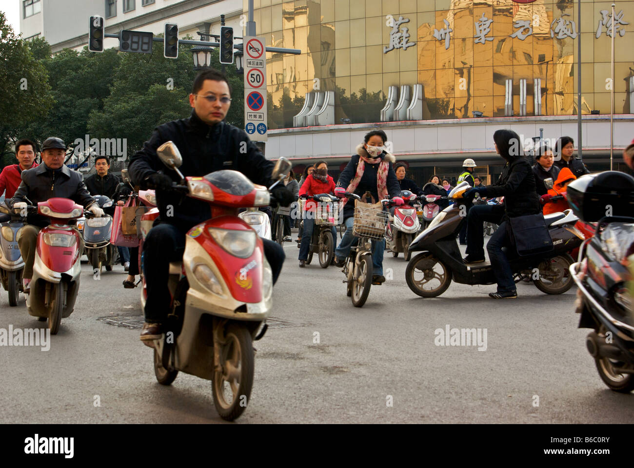 A chaotic crowd of commuters on regular and electric bicycles during ...