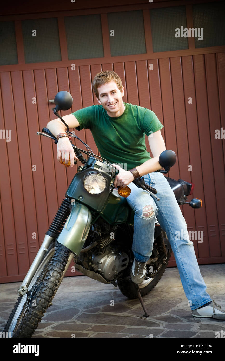 Portrait of young man sitting on vintage motorbike Stock Photo - Alamy