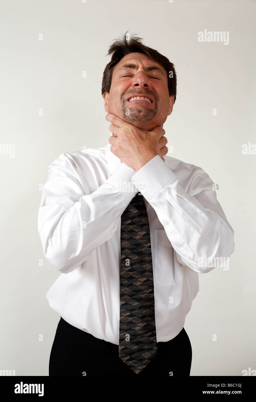 Male businessman 45 years old strangling himself Stock Photo - Alamy