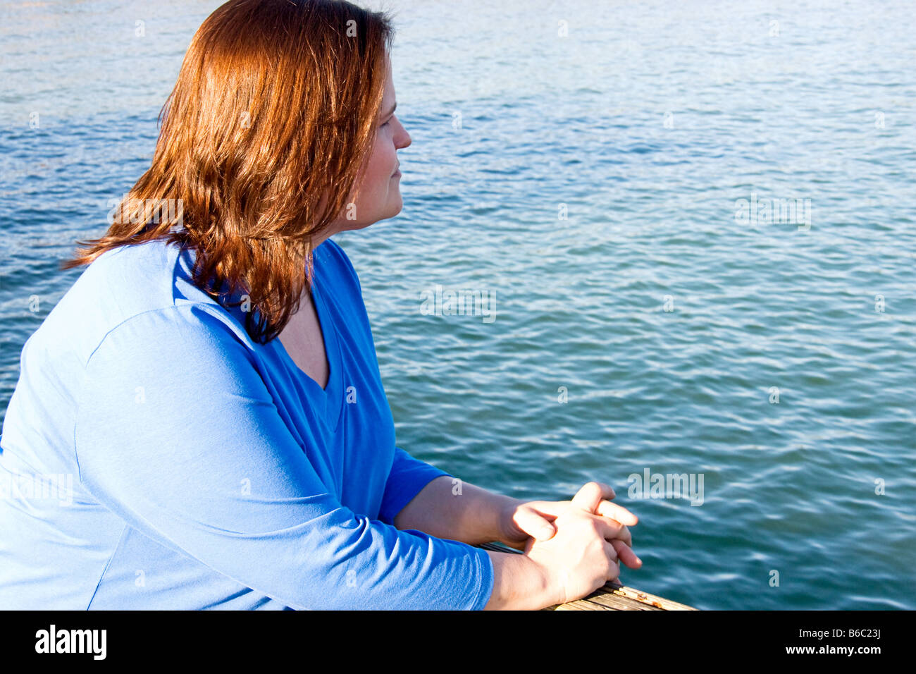 Beautiful plus sized model relaxing by the ocean Stock Photo - Alamy