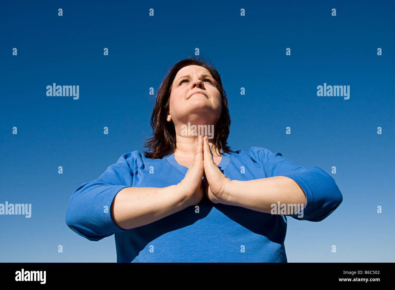 Happy praying woman praise hi-res stock photography and images - Alamy