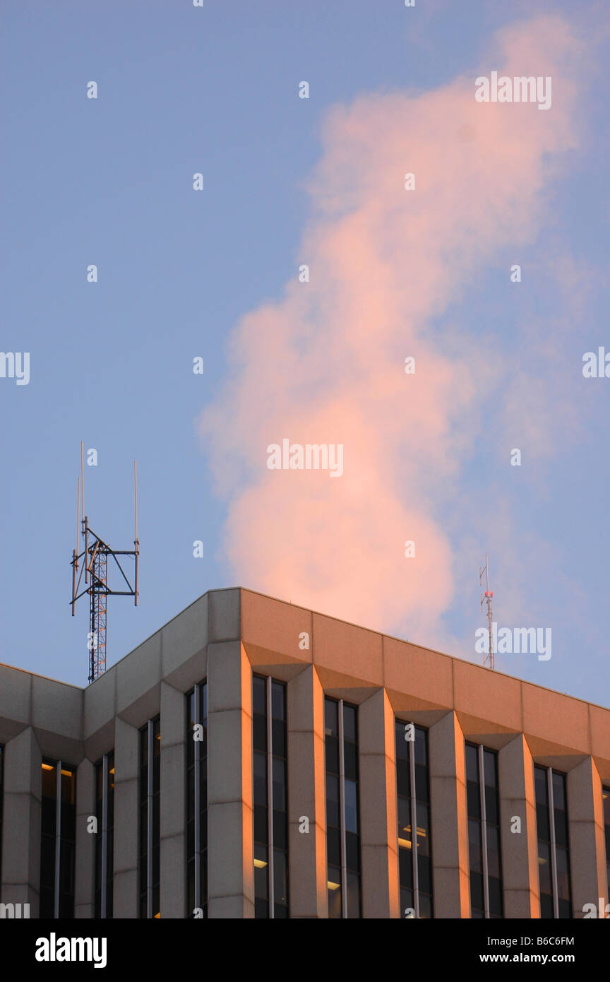 An exhaust plume rises above a tall building Stock Photo - Alamy