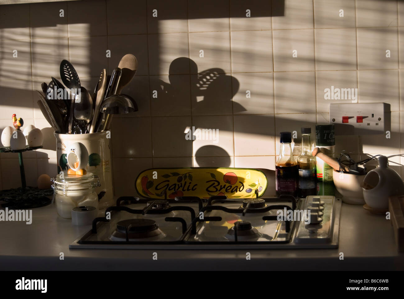 A Shady lit Gas Hob with Cooking Paraphernalia surrounding Stock Photo ...
