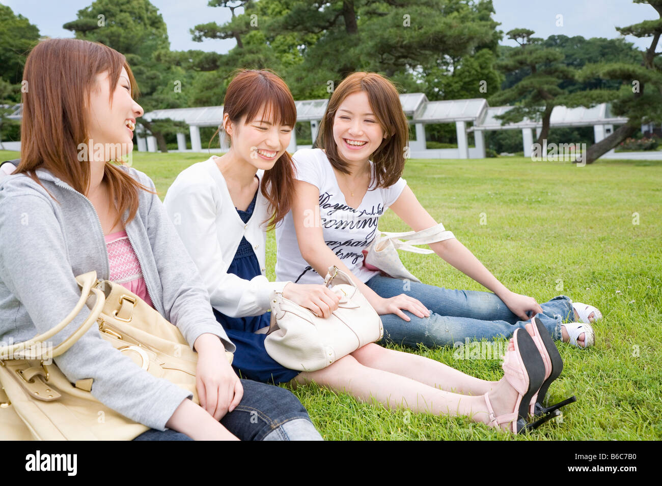 College students sitting on lawn Stock Photo - Alamy