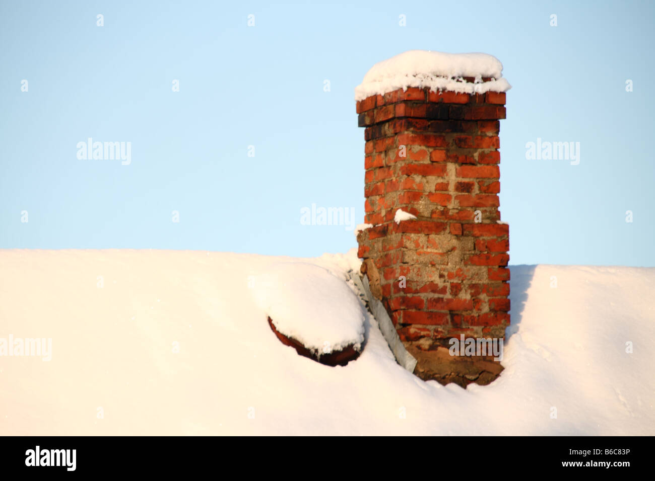 Chimney from red bricks on a snow covered roof Stock Photo - Alamy