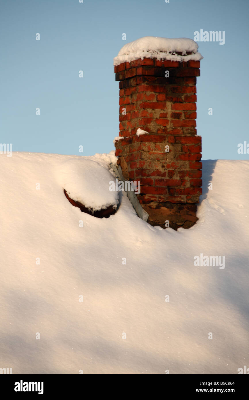 Chimney from red bricks on a snow covered roof Stock Photo - Alamy