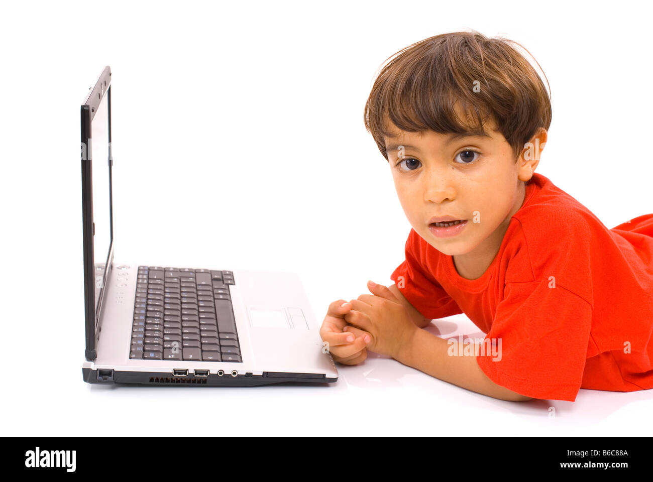Preschool Boy using a laptop over white Stock Photo - Alamy