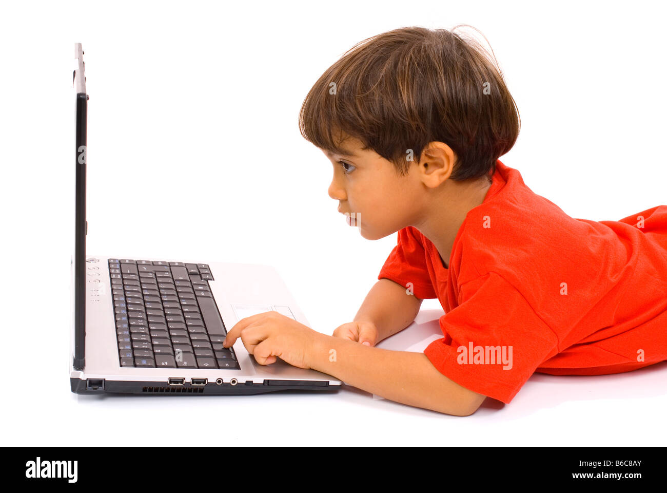 Boy accessing the internet from the laptop Stock Photo - Alamy