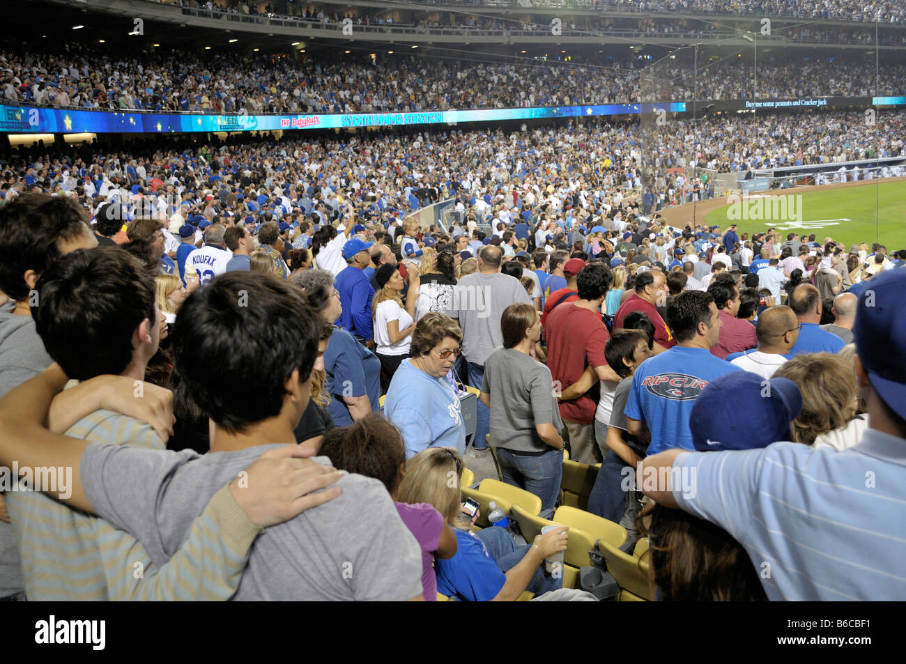 Sports fans standing in the stadium seating Stock Photo - Alamy