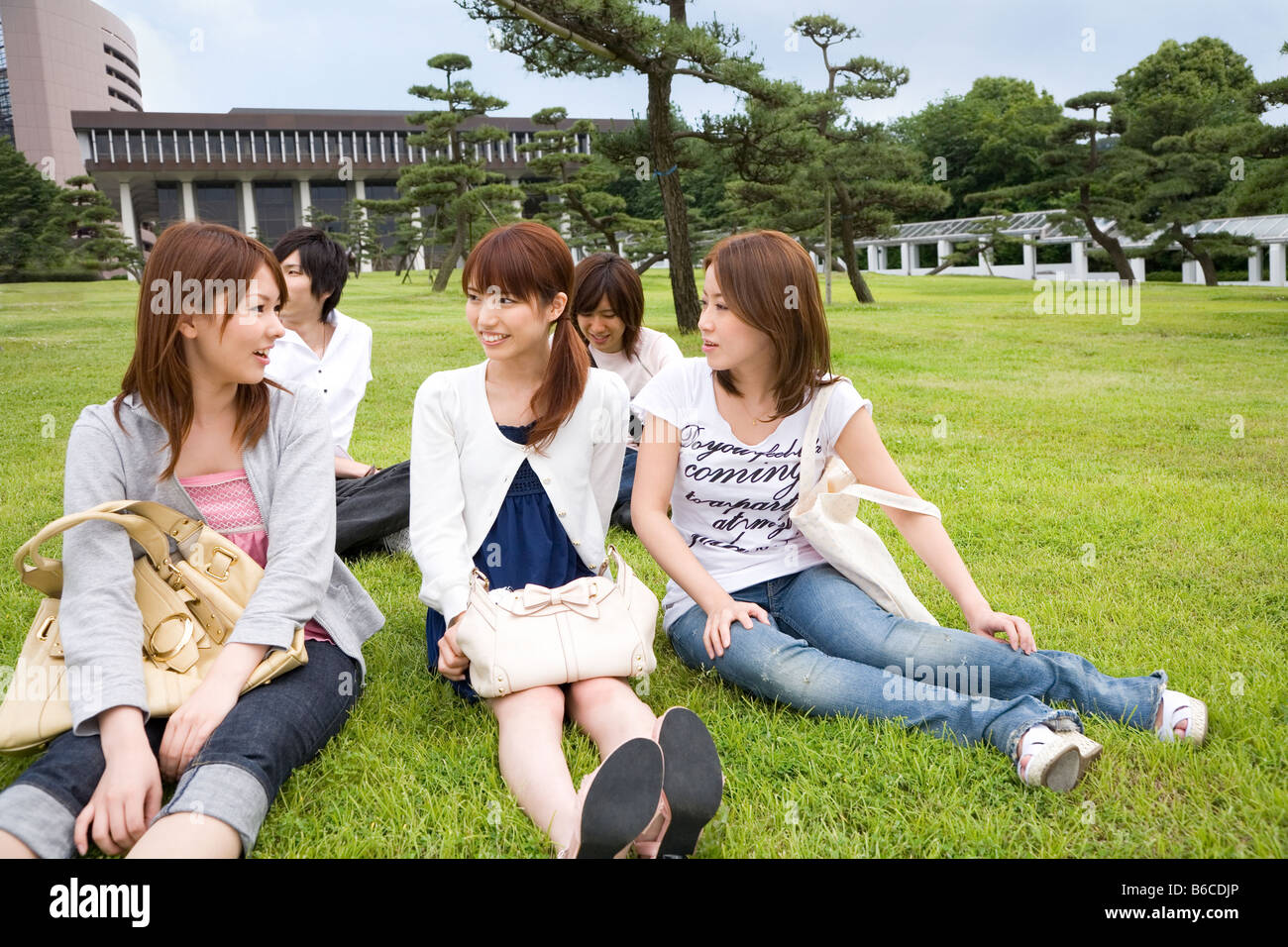 College students sitting on lawn Stock Photo - Alamy