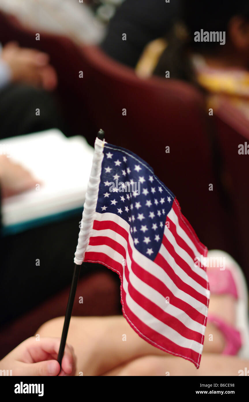 American flag in girl hand at citizenship ceremony Stock Photo - Alamy