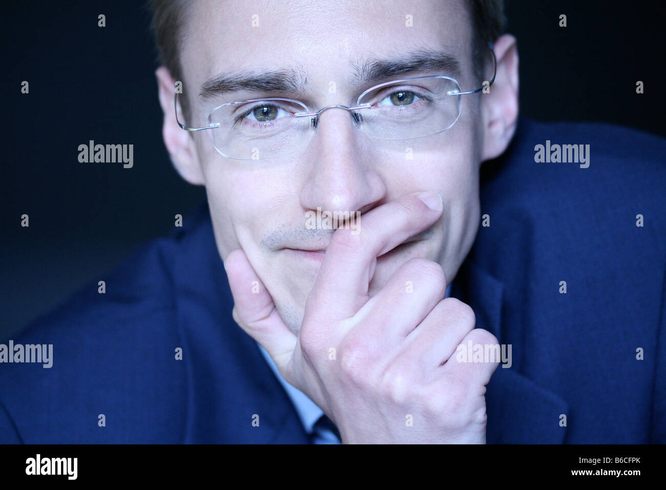 Portrait of businessman thinking Stock Photo - Alamy