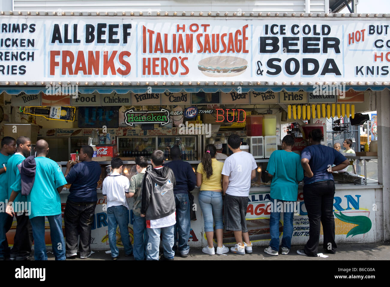 Young people get food at concessions on the boardwalk at Coney Island ...