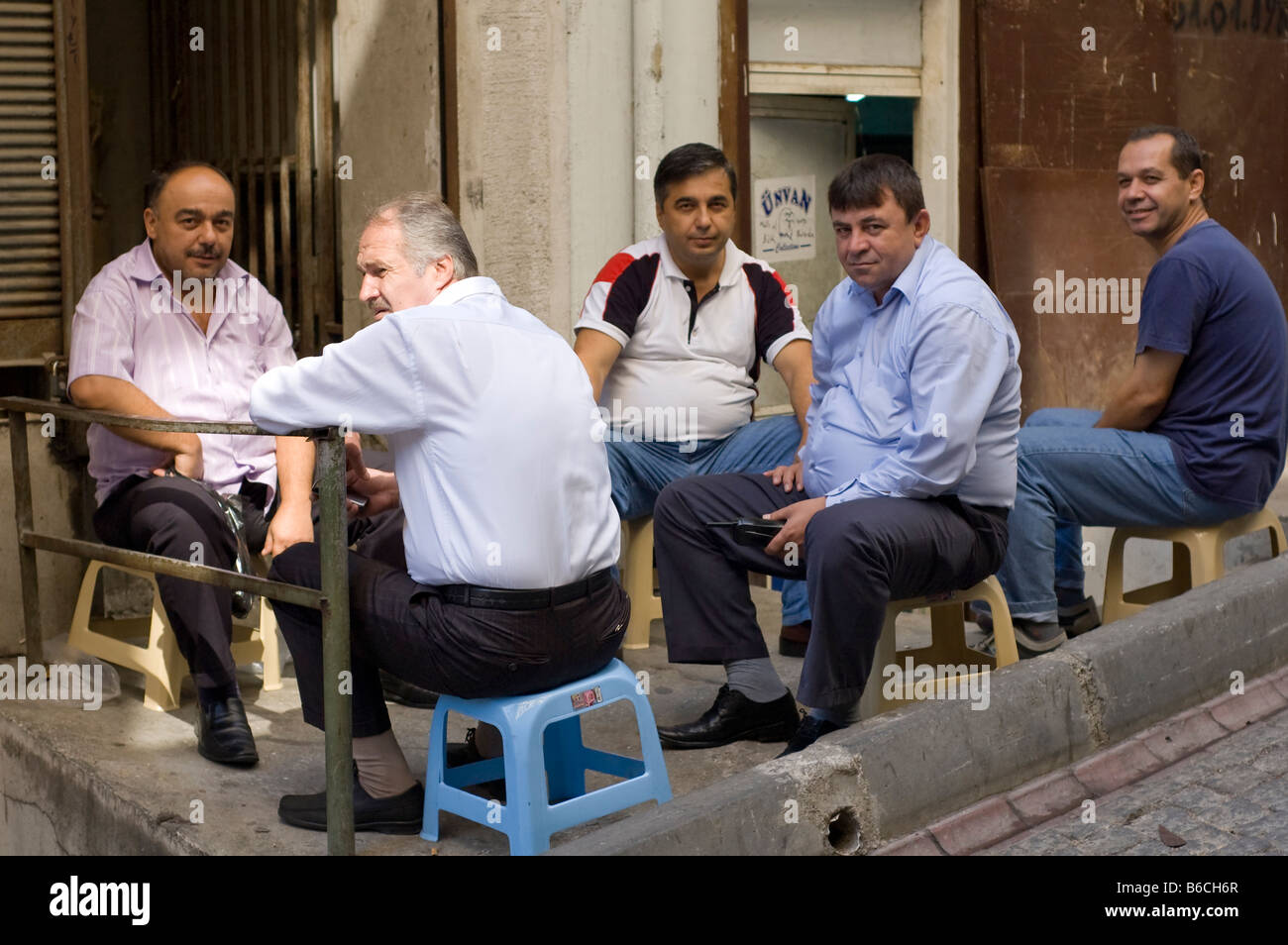 Group of men sitting at the table Stock Photo - Alamy