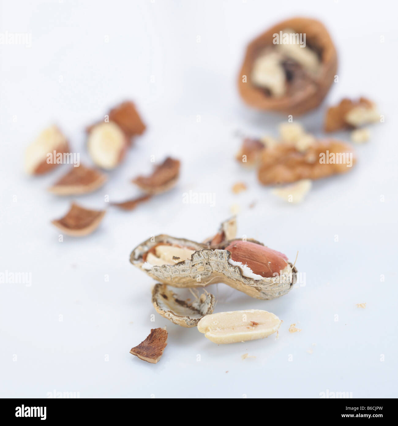 Close-up of peanuts and walnut on white background Stock Photo - Alamy