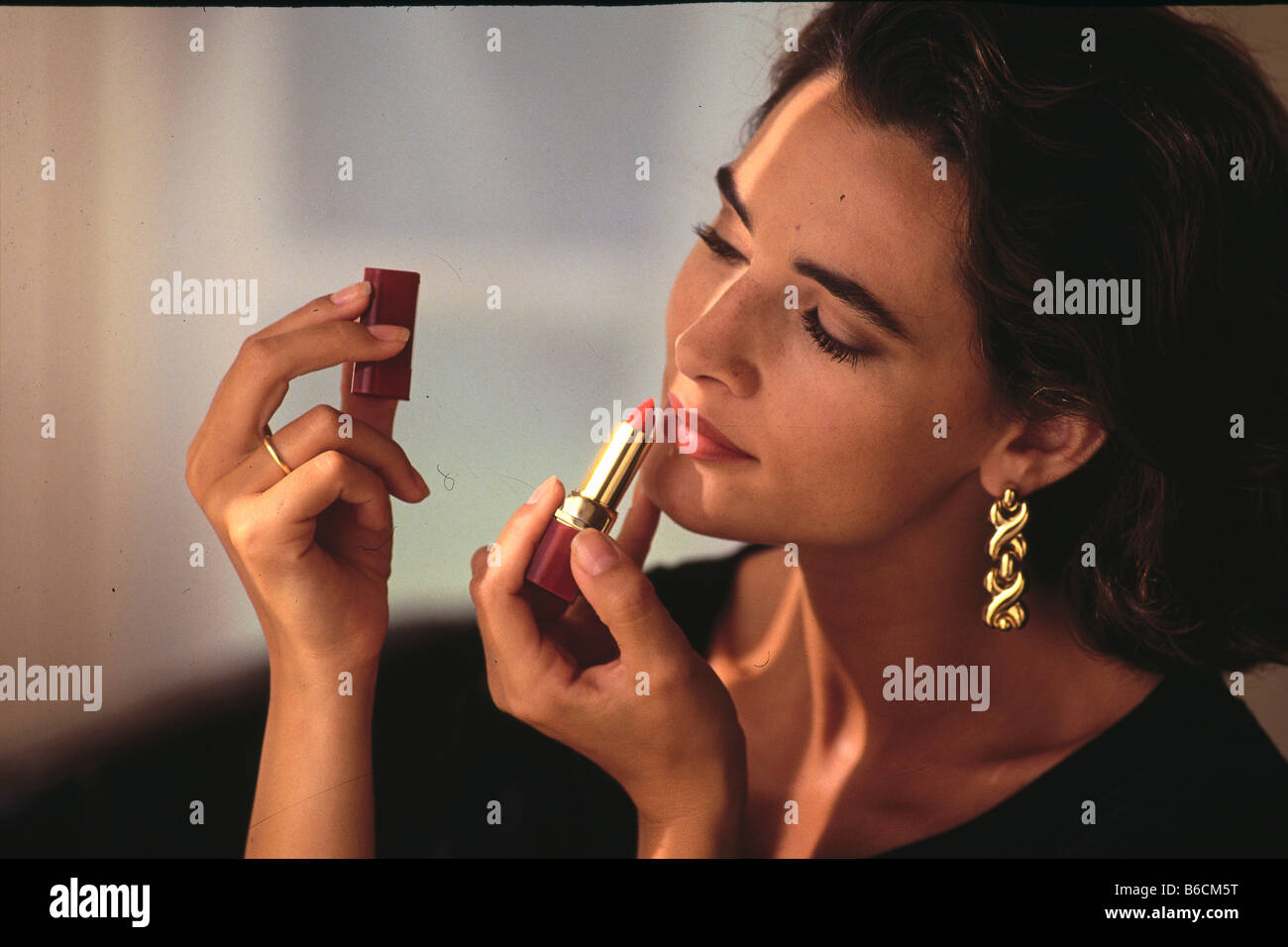 Close-up of woman applying makeup Stock Photo - Alamy