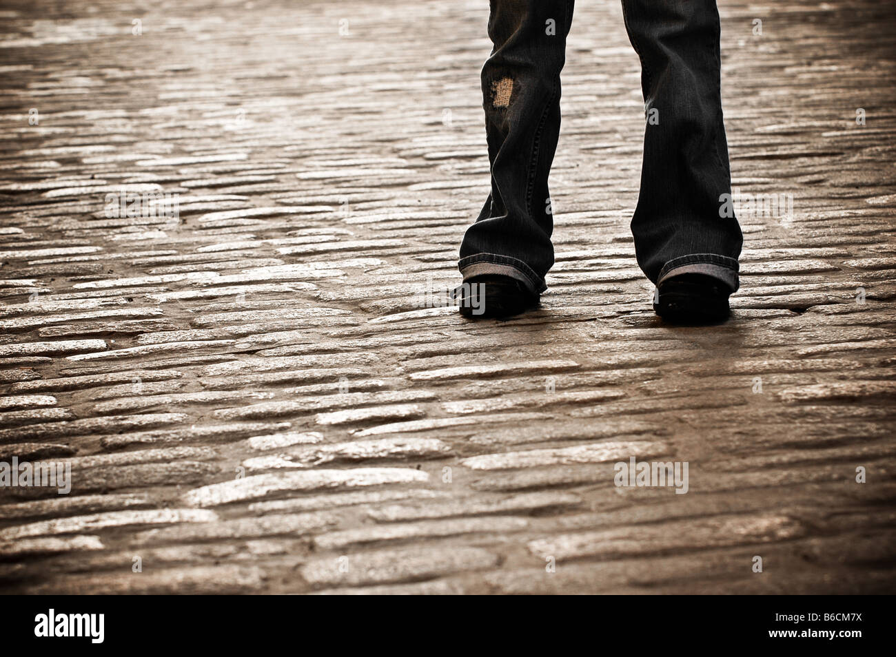 Rough cobble stones with persons legs Stock Photo - Alamy