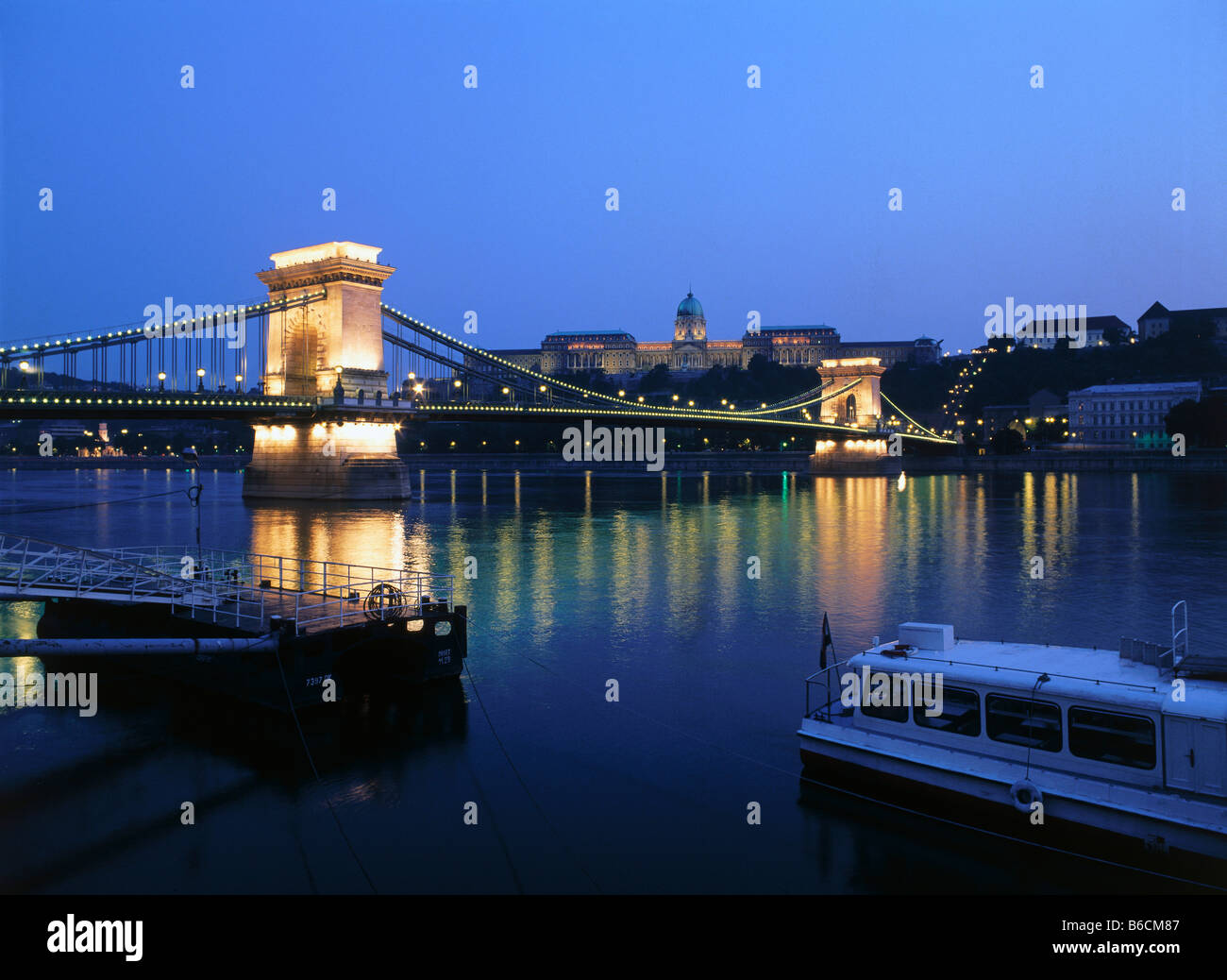 Bridge across river lit up at night Stock Photo - Alamy
