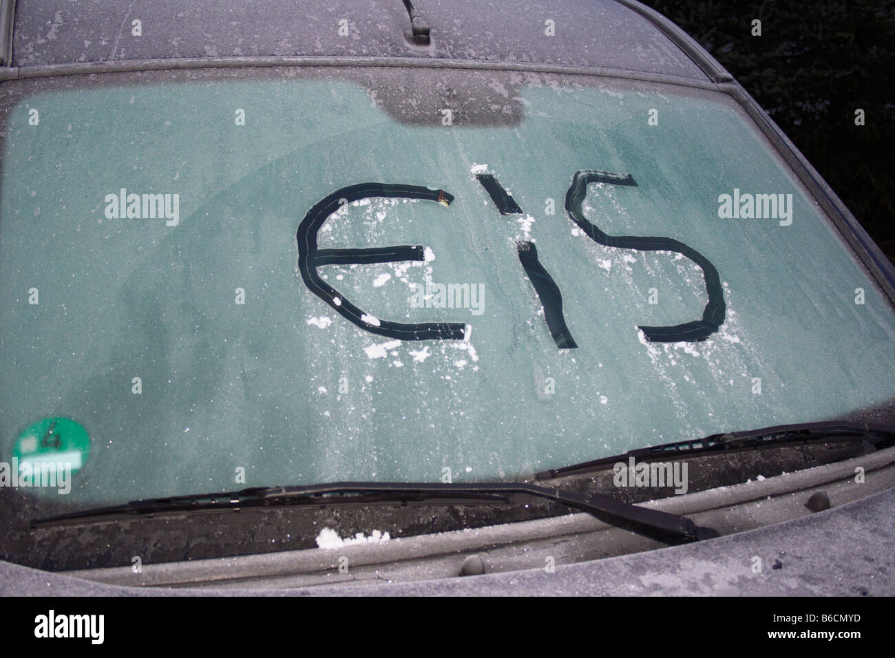 German word "EIS" written on frozen windshield of a car. Photo by Willy ...