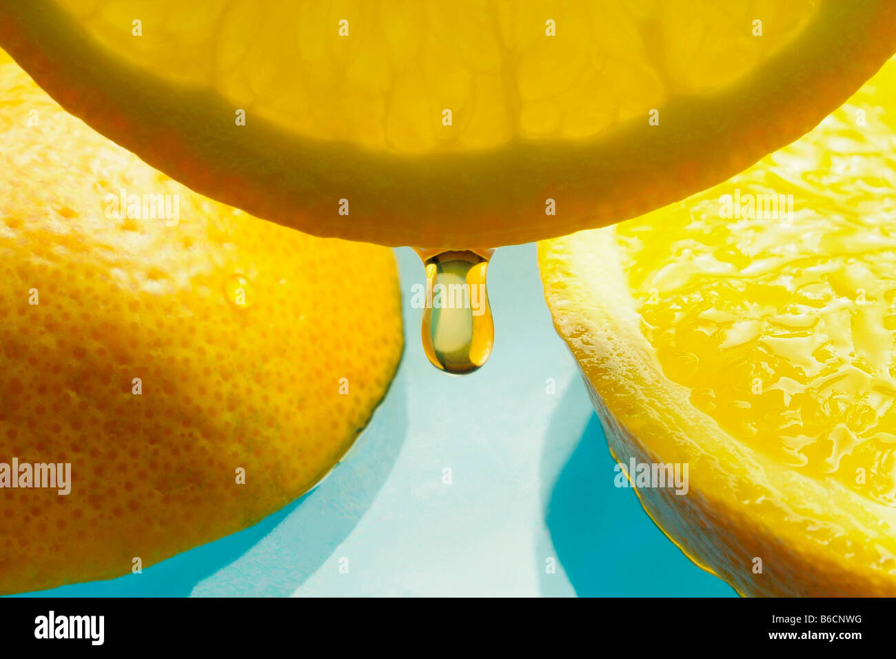 Close-up of drop of lemon juice dripping from slice of lemon Stock ...