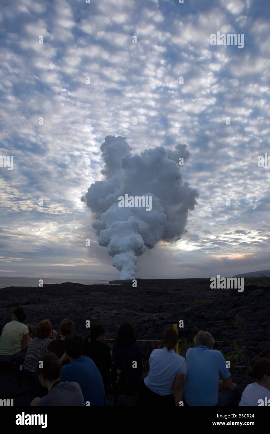 Spectator look on as smoke bellows out of a volcanic vent in Hawaii ...