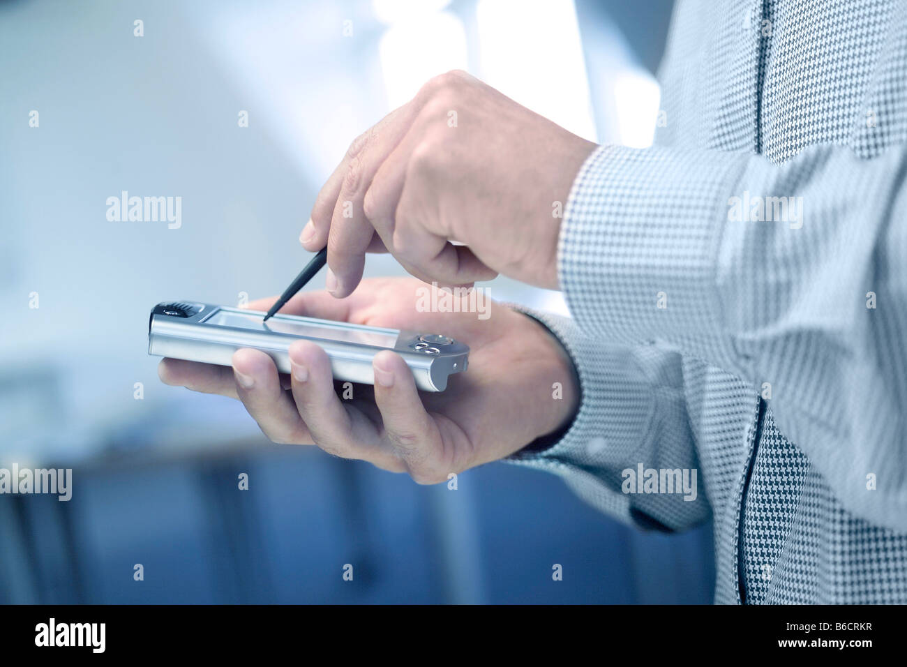 Mid section view of businessperson using PDA Stock Photo - Alamy