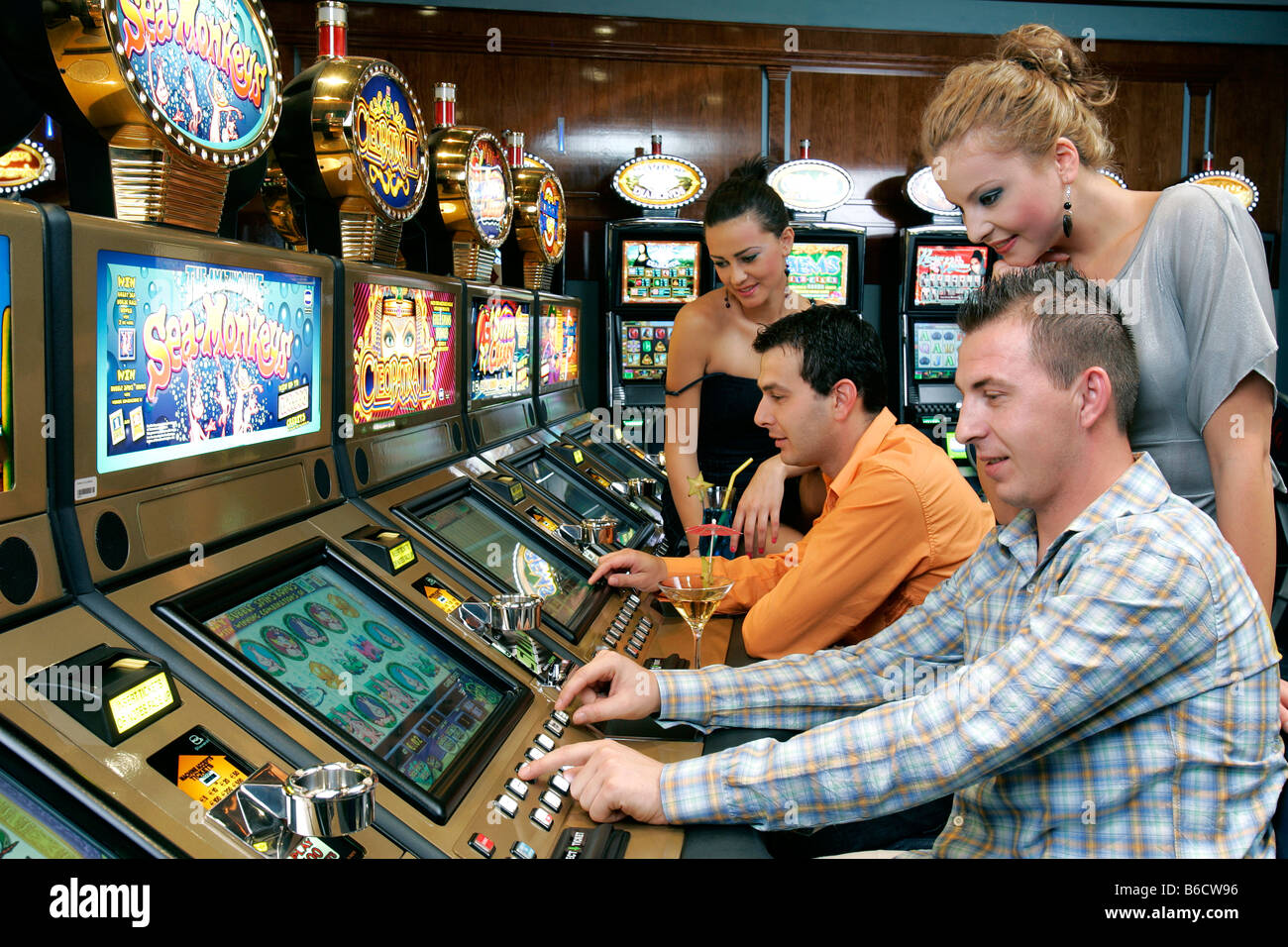 Girl playing fruit machine hi-res stock photography and images - Alamy