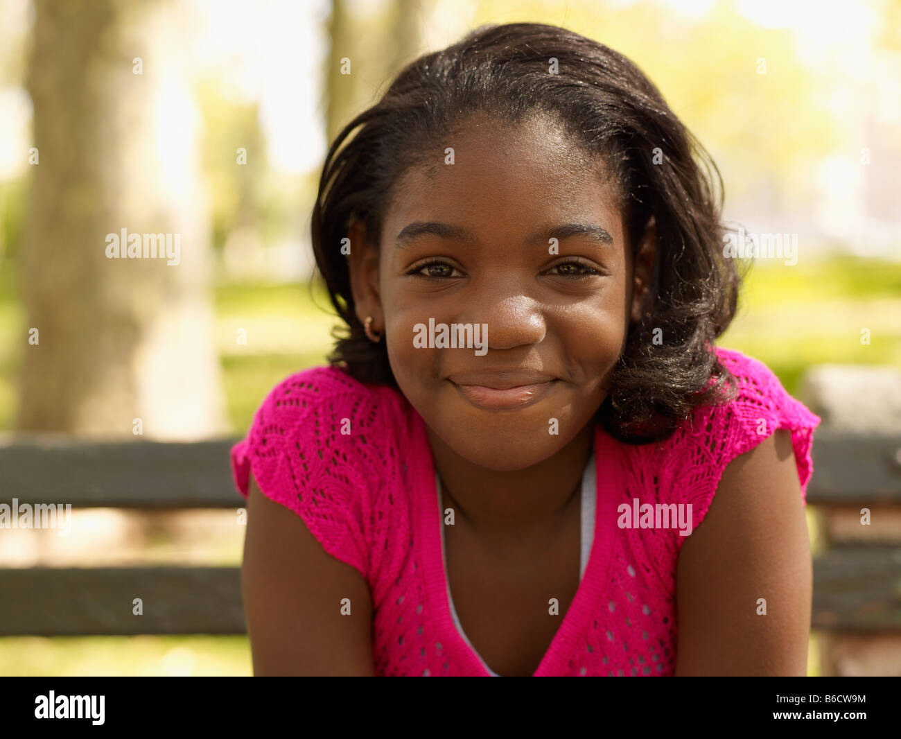 Smiling African girl in park Stock Photo - Alamy
