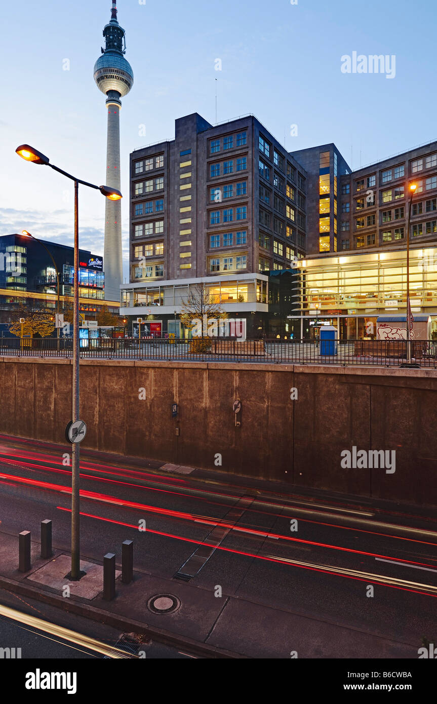 Lamp post in front of buildings lit up in city Stock Photo - Alamy