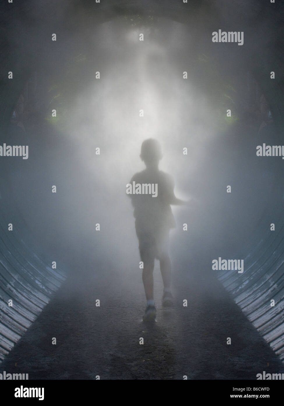 CHILD RUNNING IN MIST TO LIGHT AT END OF TUNNEL Stock Photo - Alamy