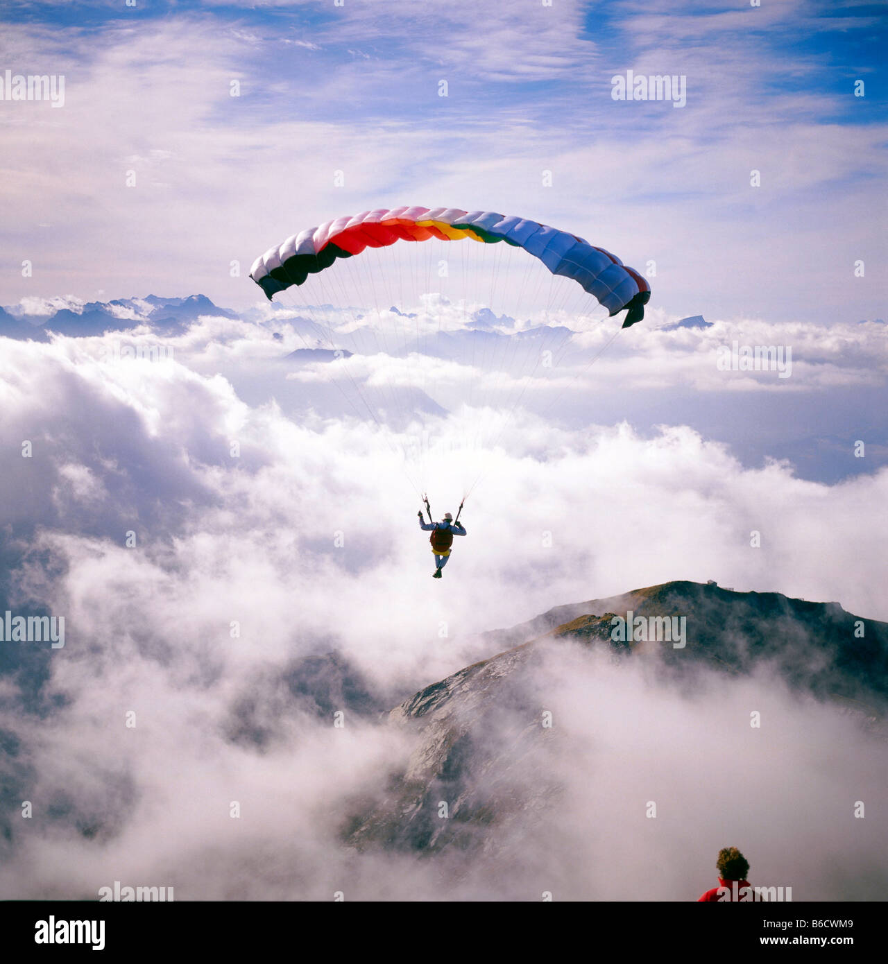 Paraglider paragliding over mountain range Allgaeu Bavaria Germany ...