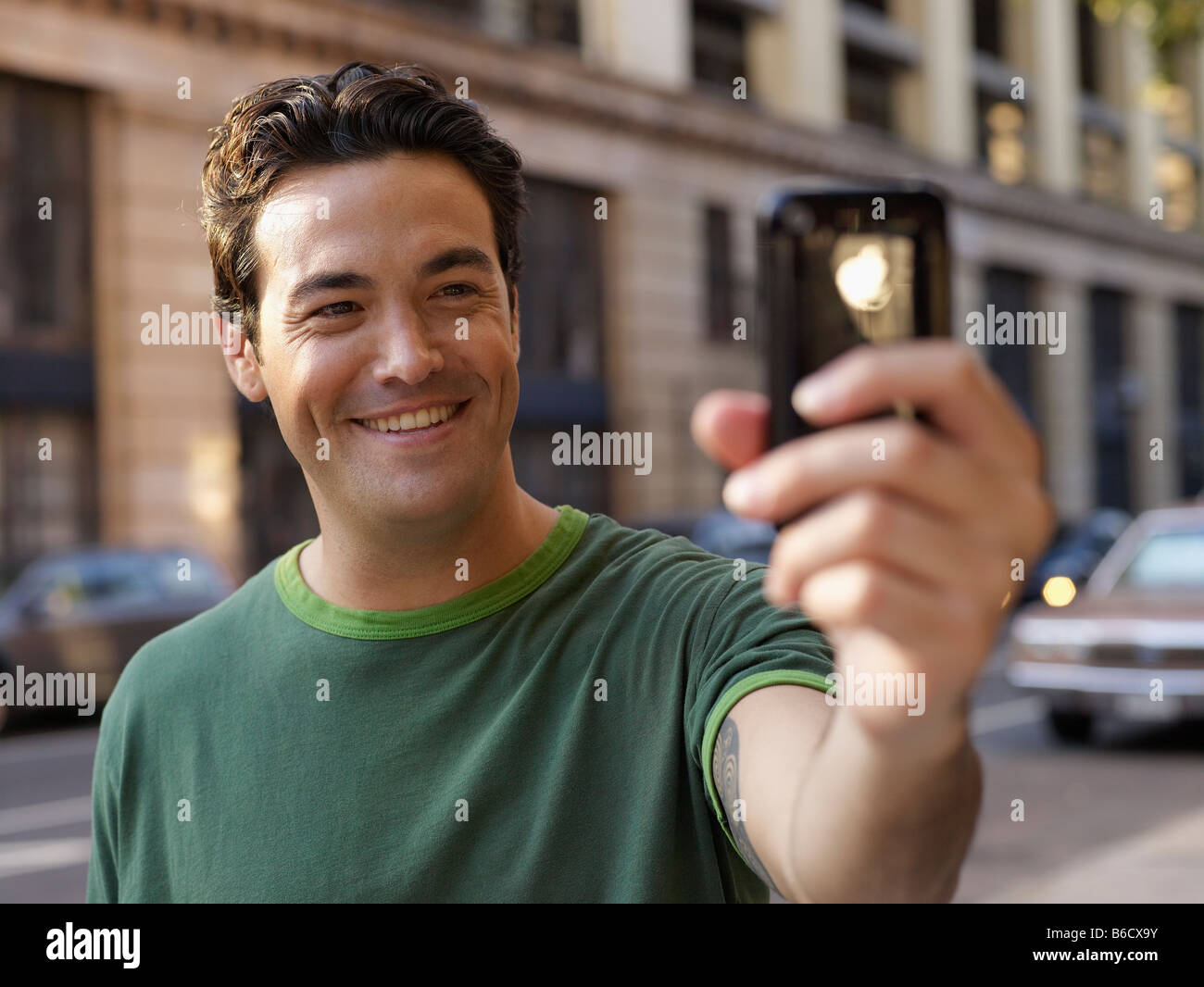 Man taking photograph with cell phone Stock Photo - Alamy