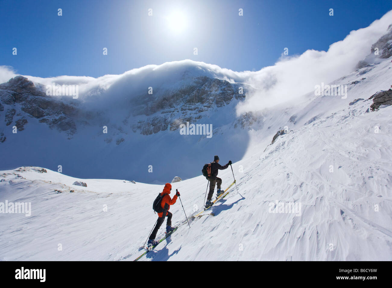 Two skiers walking with skis on snowcovered mountain, Lungau ...