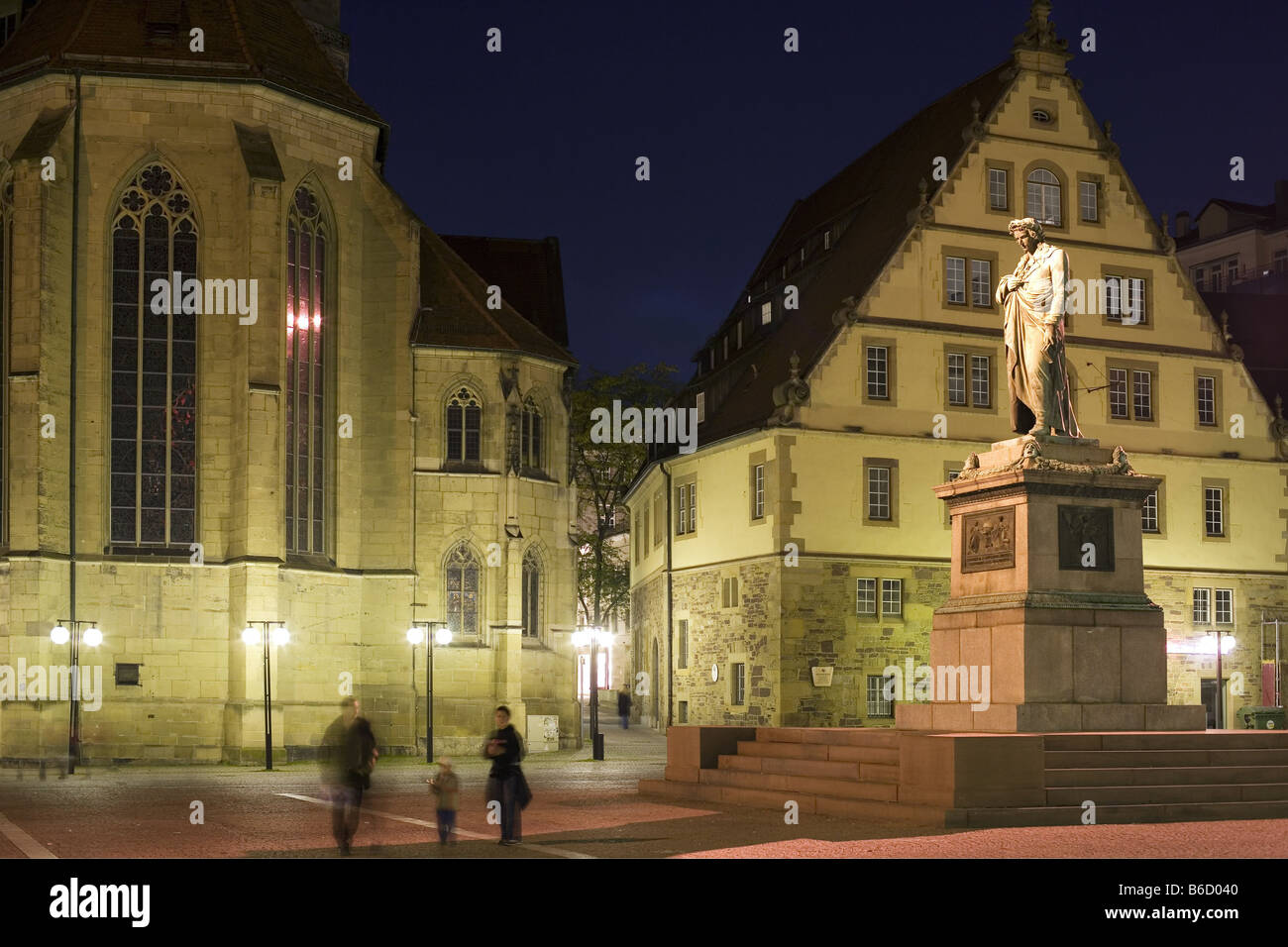 Three people standing in front of memorial, Schillerplatz, Stuttgart ...