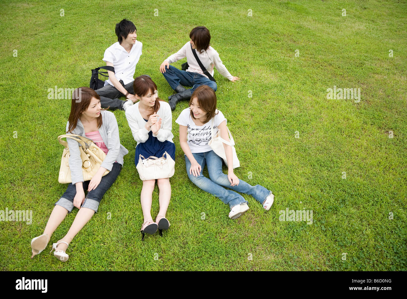 College students sitting on lawn Stock Photo - Alamy